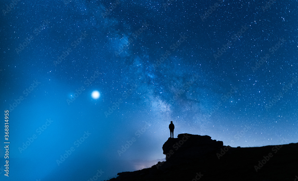 Person contemplating the vastness of the universe. Small silhouette of ...
