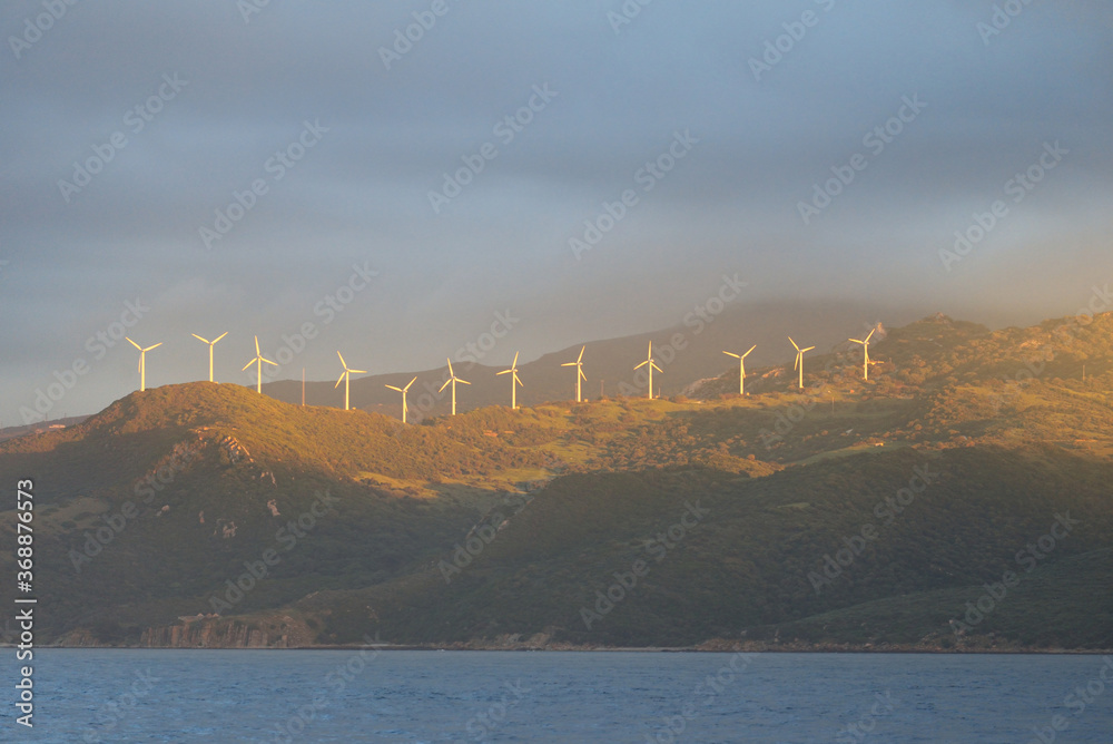 Foto stock di Wind turbines at the Rock of Gibraltar at sunrise, a view ...