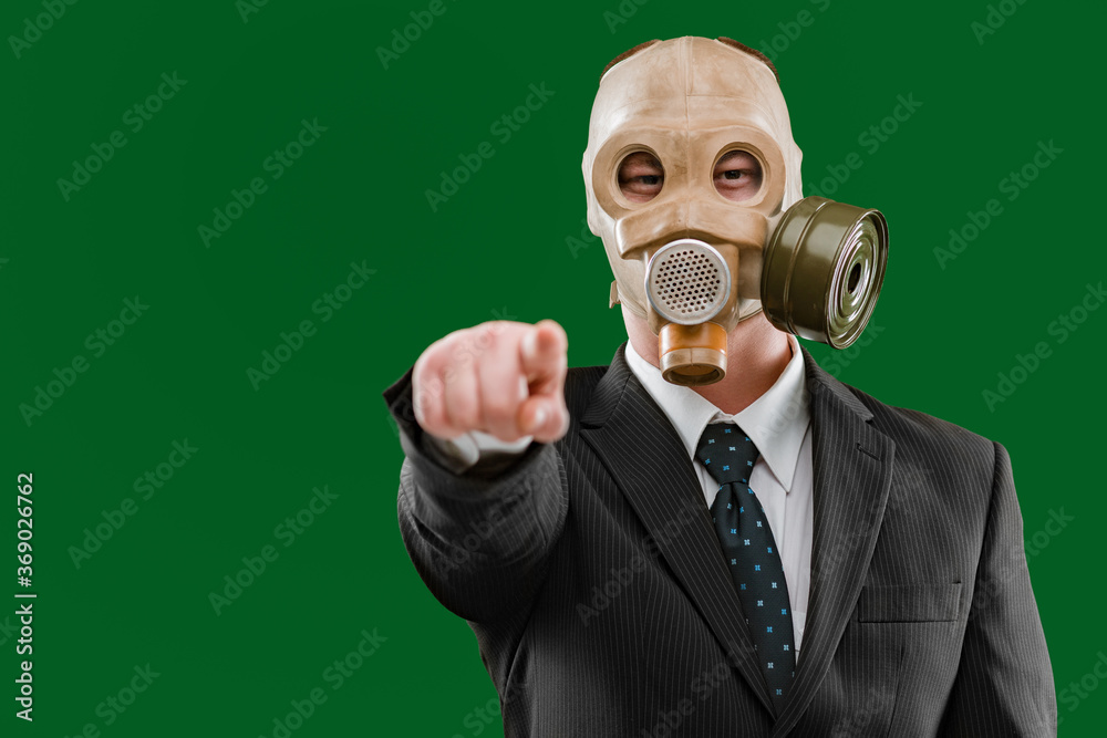 Portrait of a man pointing towards the camera, wearing a dark business ...