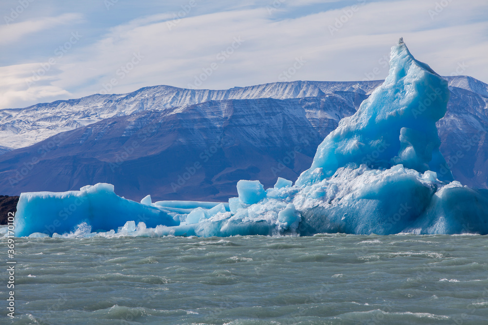 Beautiful turquoise iceberg floating on the glacial milk river water in ...