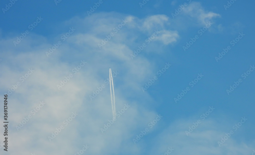 Airplane flying in the clear blue sky and contrail against, Engine ...