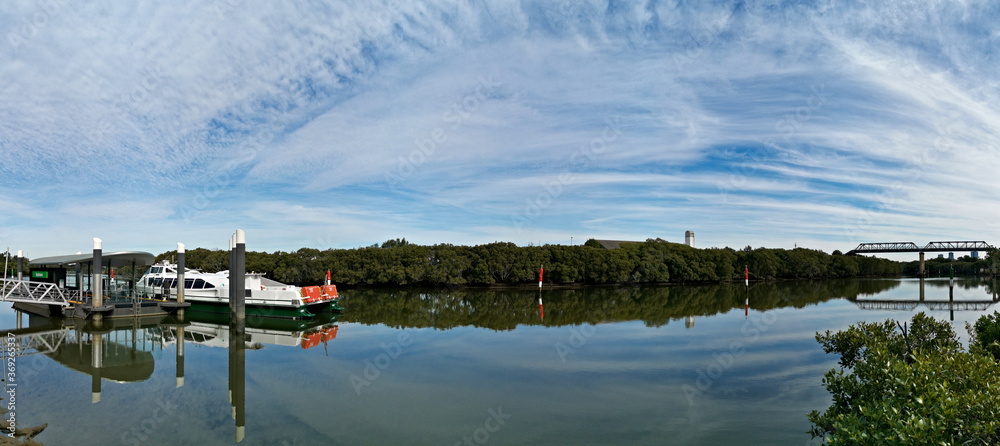 Beautiful panoramic view of a river with reflections wharf, trees, deep ...