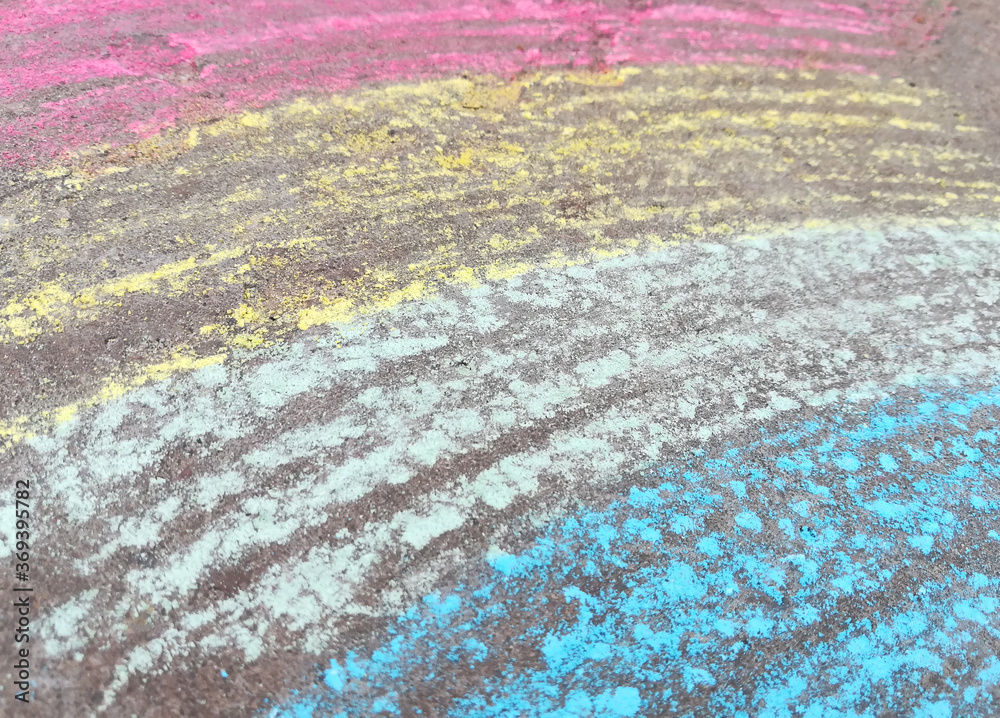 rainbow is drawn with chalk on the asphalt. colored summer background ...
