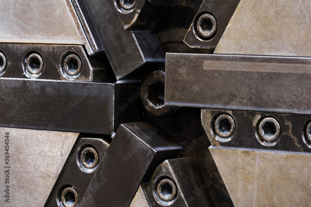 industrial background - lathe spindle chuck with six jaws close up ...