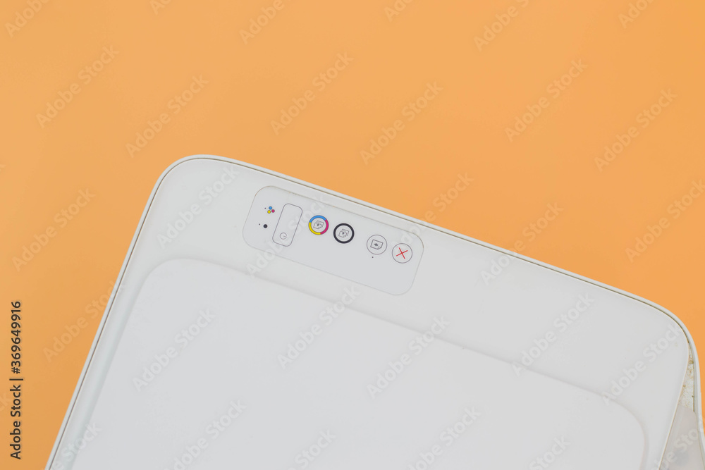 Scanner for scanning and printing images, on a yellow background ...