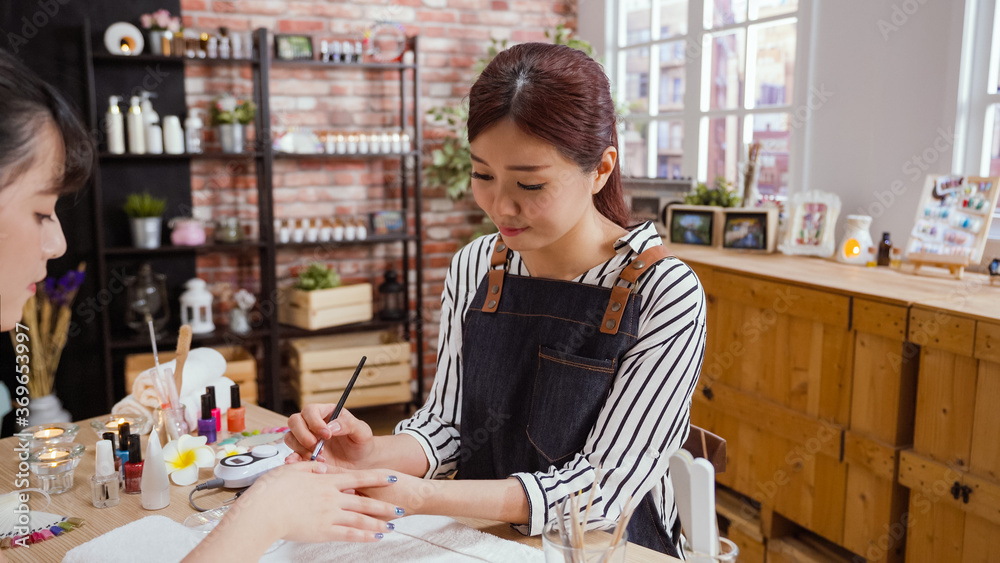 Woman customer getting artificial nails done in beauty salon studio ...
