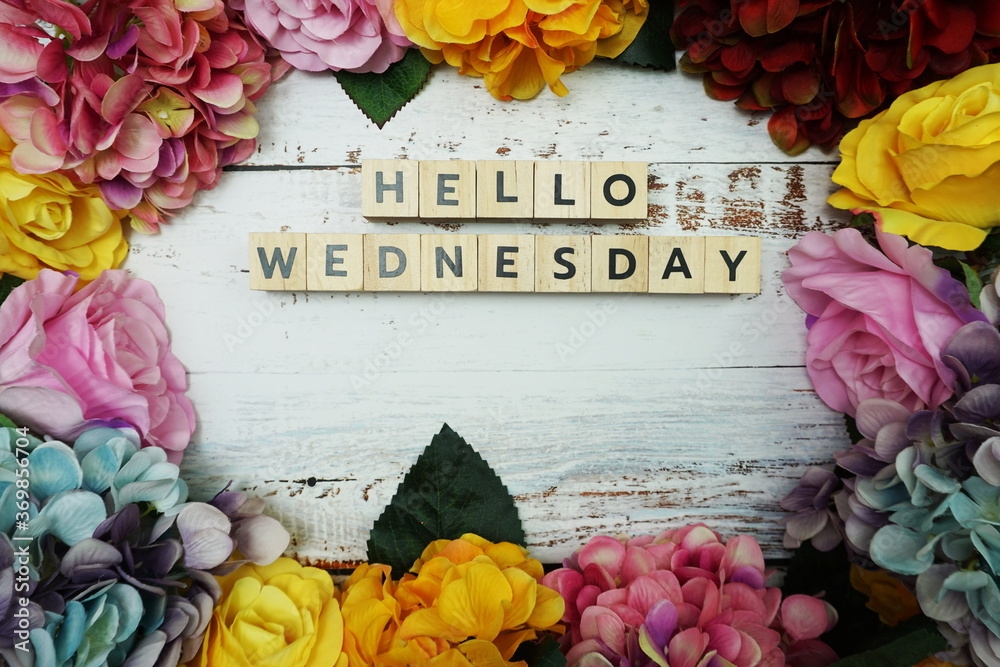 Hello Wednesday alphabet letter with colorful flowers border frame on ...