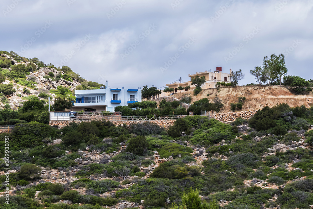 Typical Greek houses located on a hillside above the exclusive Bay of ...