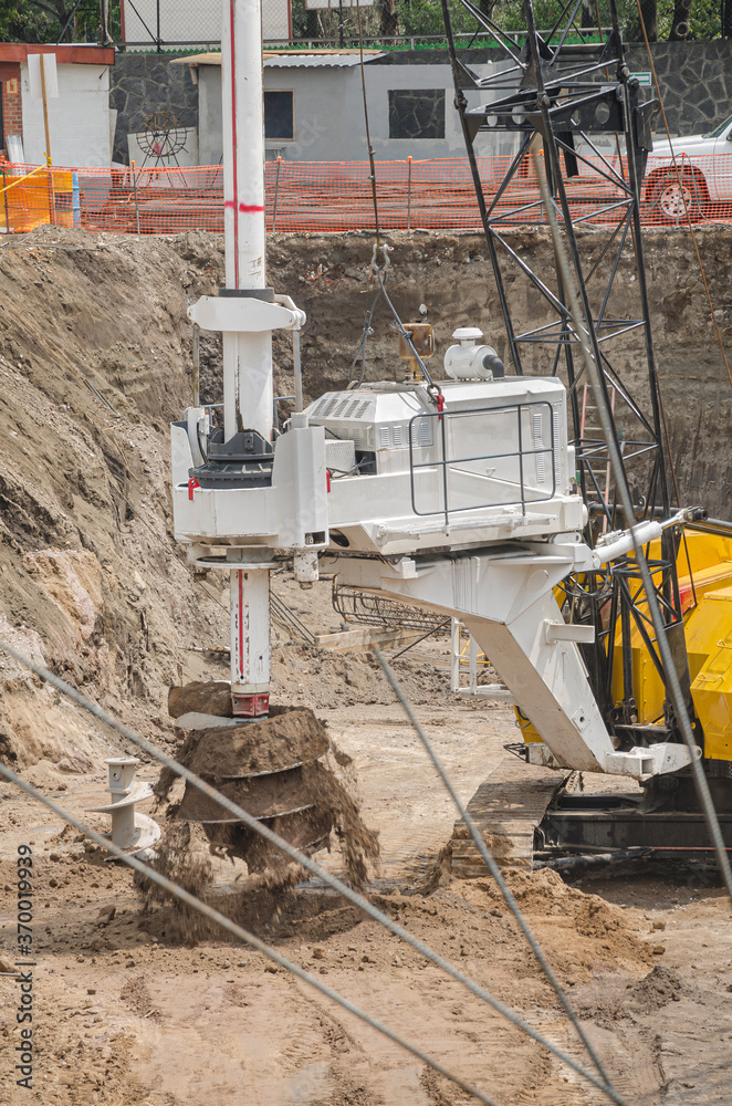 Drilling tractor vehicle in construction site Driller removing earth ...