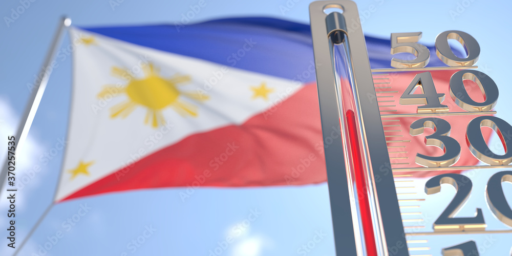 Thermometer shows high air temperature against blurred flag of ...
