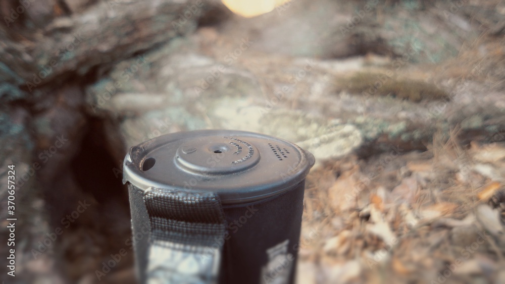 Close-up of a gas burner, on which a kettle with a lid stands, boils ...