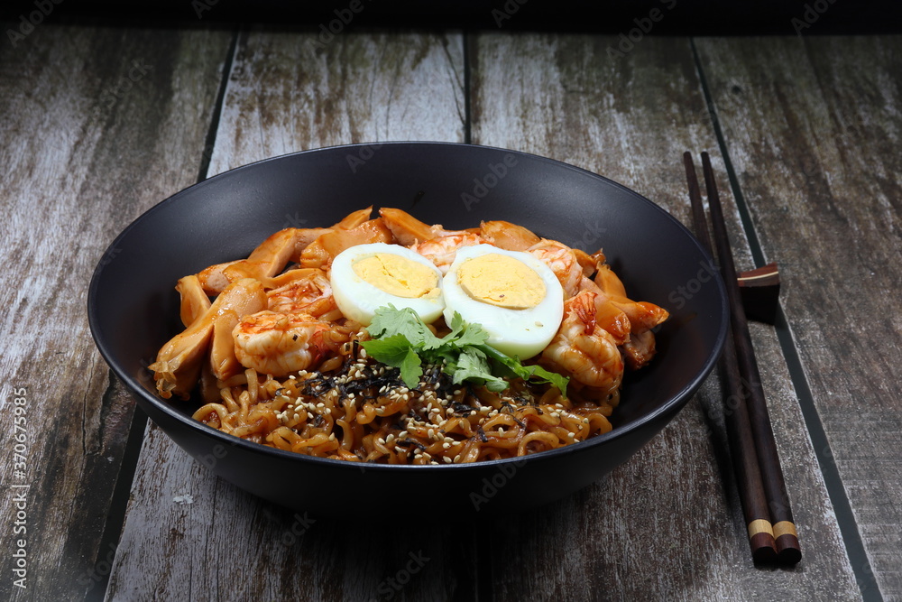 Traditional spicy noodle menu in Korea style topping with boiled egg ...