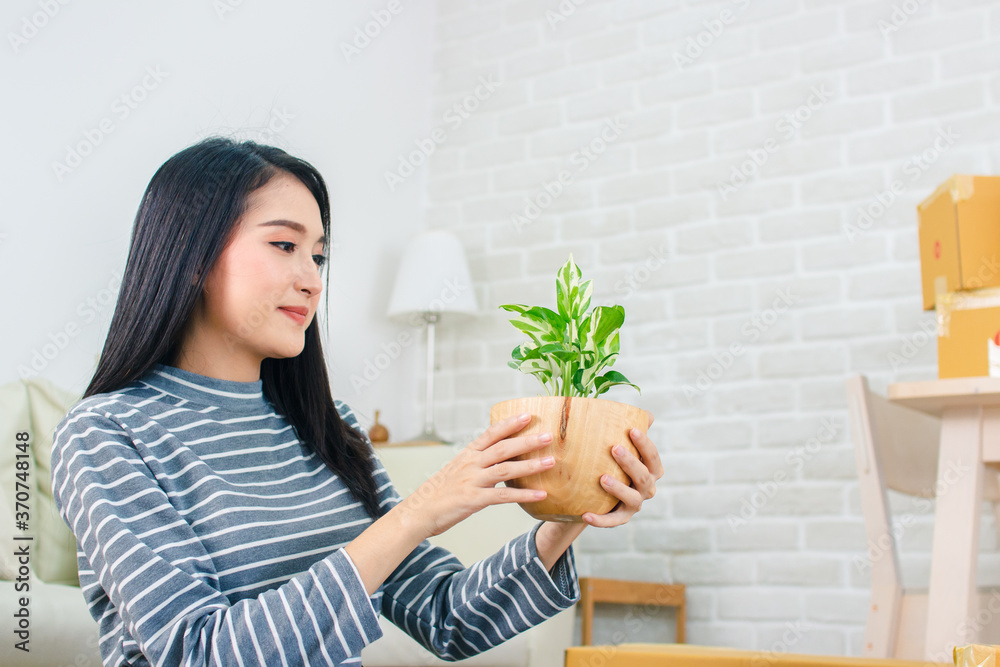Beautiful young asian and friend happy holding tree from boxes smiling ...