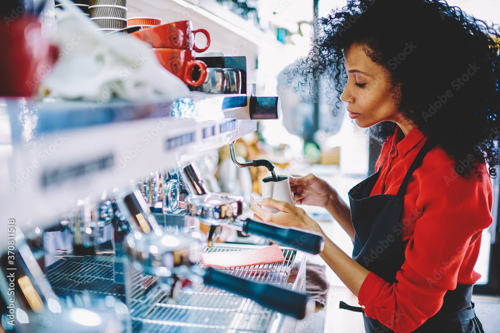 Side view of pensive african american female waitress in black apron ...