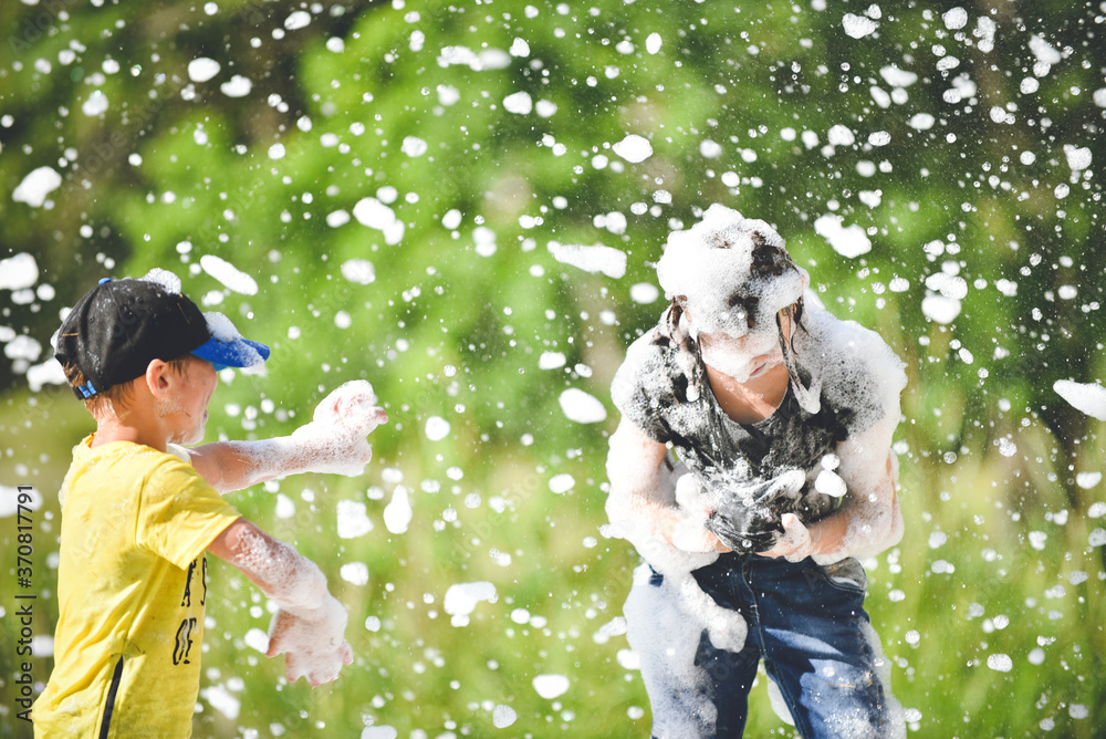 Stock-Foto „Young people in the foam. A foam party. Group of children ...