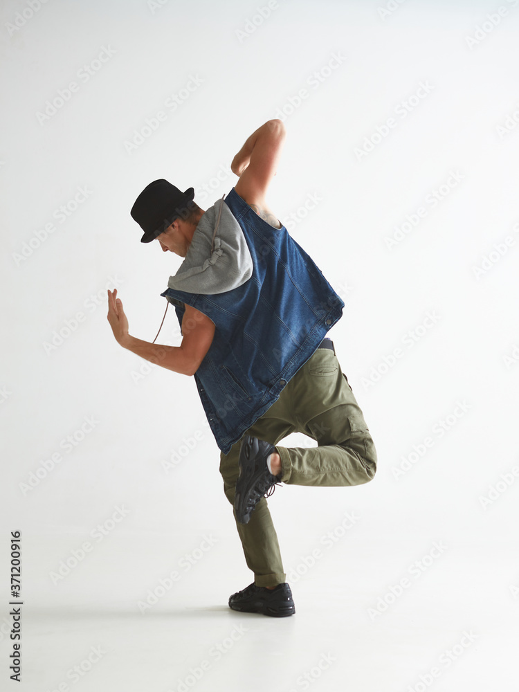 Cool guy breakdancer in hat dancing hip-hop in studio isolated on white ...