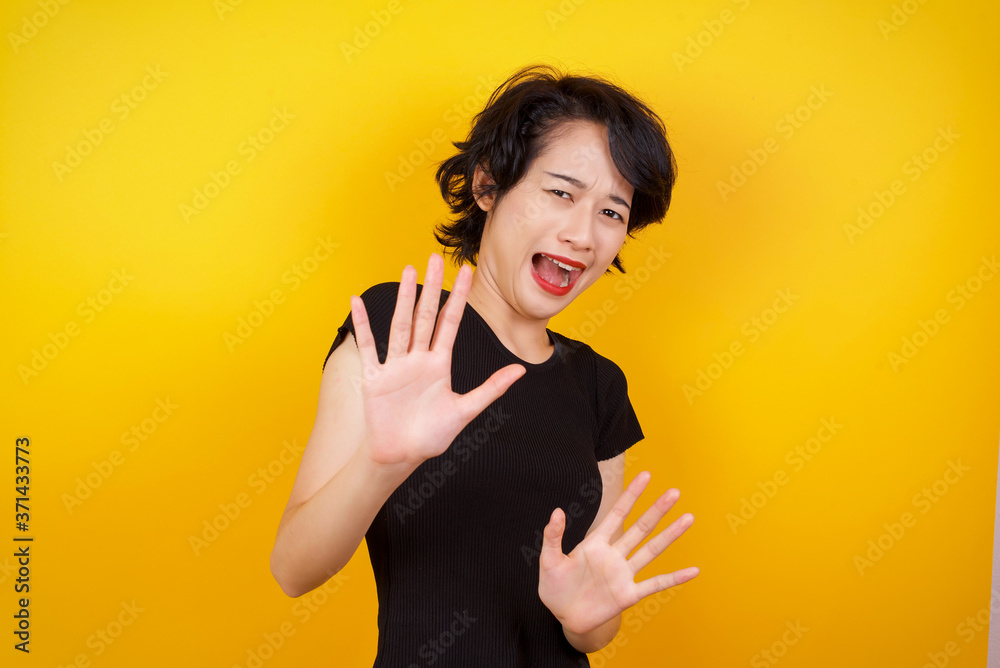 Dissatisfied female model frowns face, has disgusting expression, shows ...