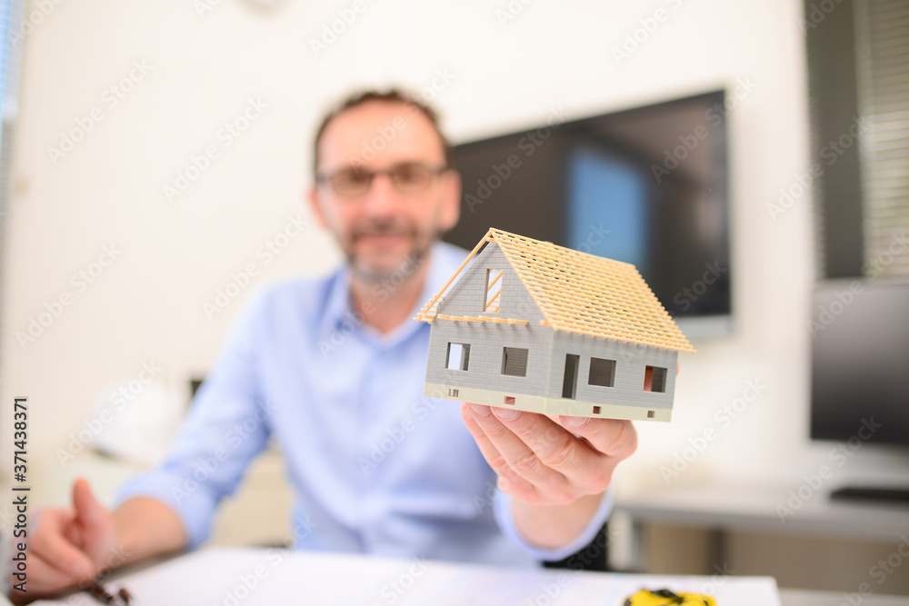 mature male architect showing a mockup sketch of architectural ...