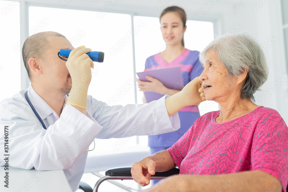 asian doctor use flashlight screening eyes of old asian patient, vision ...