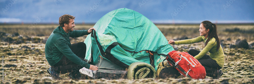 Camping people couple tourists having fun together enjoying putting up ...