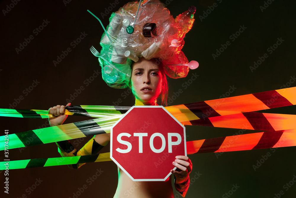 Portrait of girl with waste, plastic bags, polyethylene, trash, garbage ...