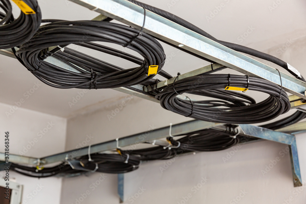 Cable management. Working wires, black cables wound into a coil, a ...