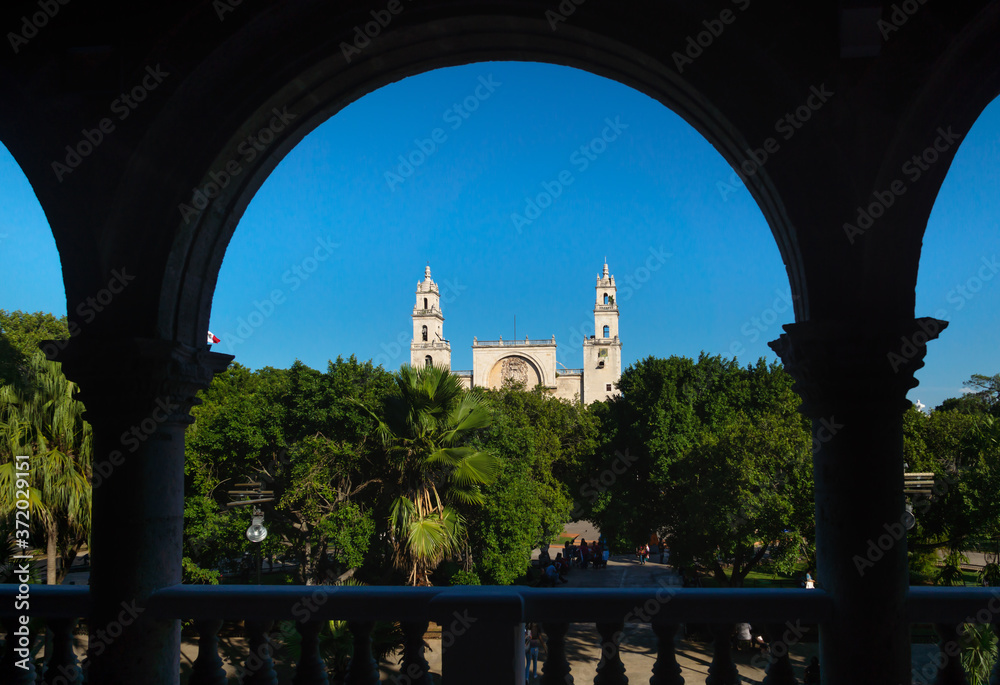 View through arches to the cathedral of Merida over the main square ...