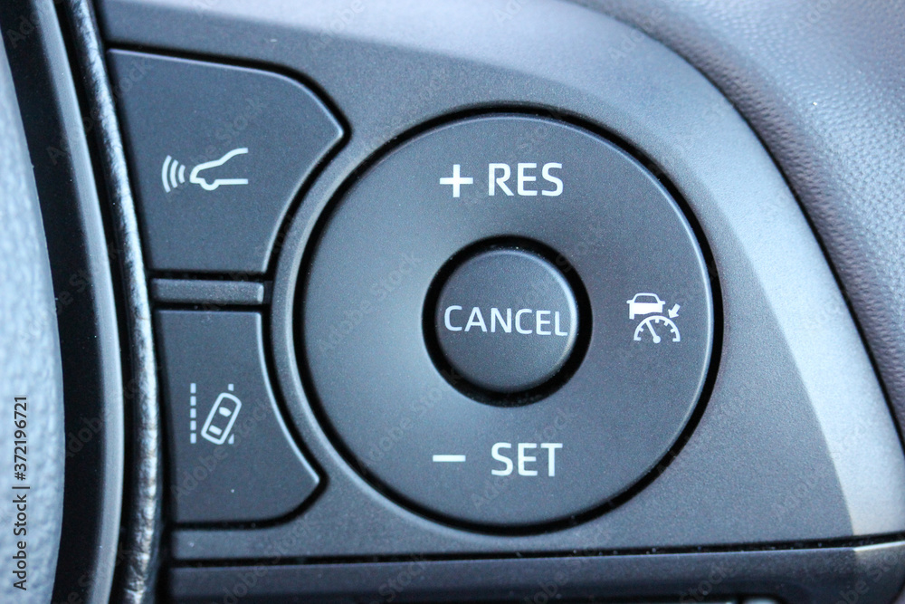 Cruise control buttons on a steering wheel Stock Photo | Adobe Stock