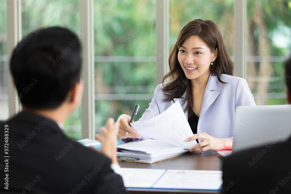 asian woman hr officer holding resume for job interview, considering ...