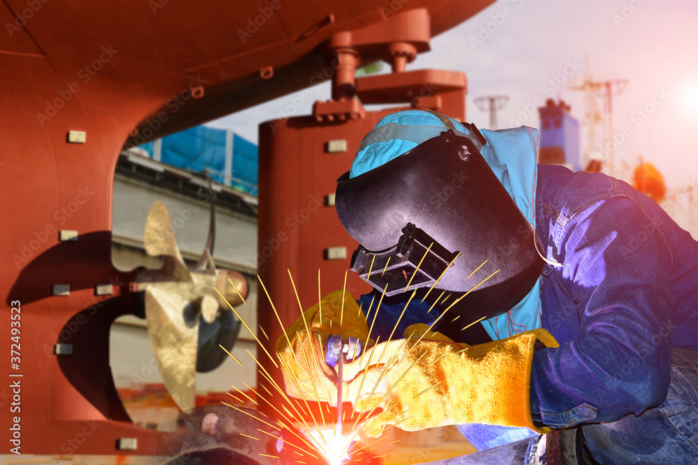 Welder is Welding ship repair on maintenance in shipyard on Propeller ...