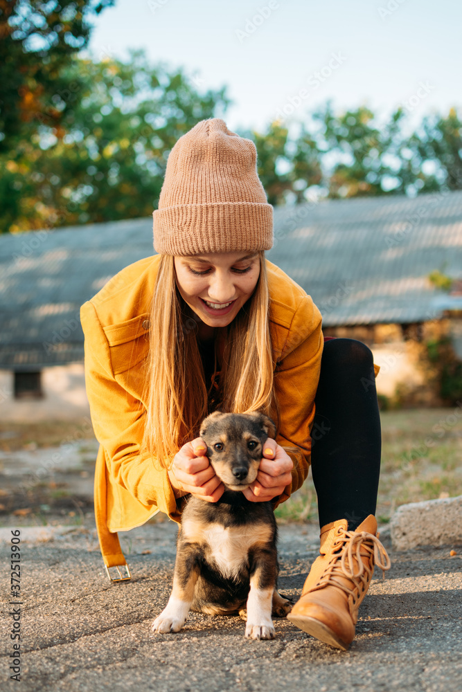 World Animal Day. Woman Volunteer meeting homeless dog puppies in fall ...