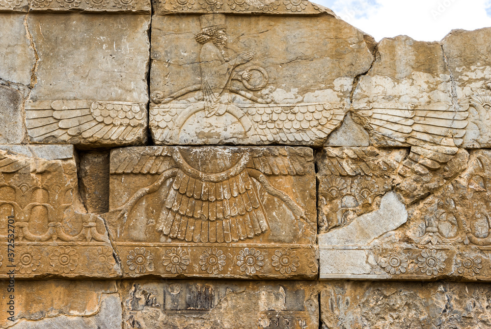 Iran. The ruins of Persepolis. A winged figure represents the God ...