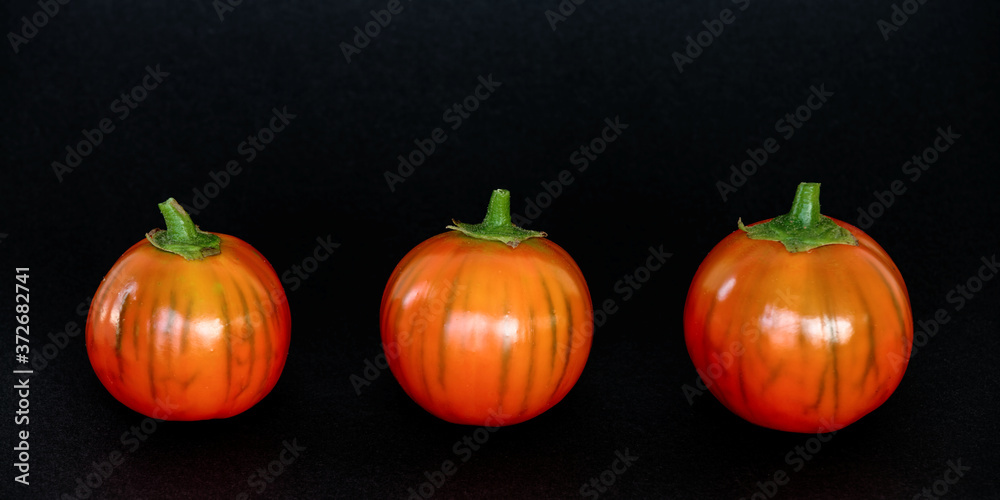 Orange color eggplants with stripes on black background. Three Turkish ...