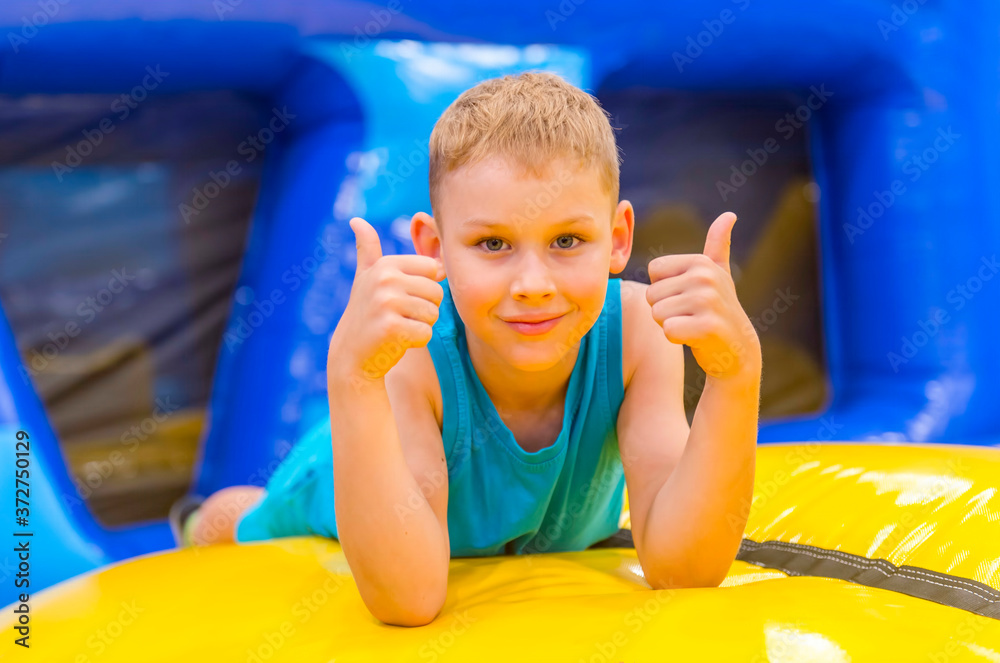Little boy on colorful playground trampoline. Kids jump in inflatable ...