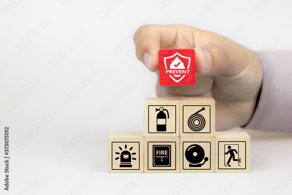 Close-up hand choose fire prevent icon on cube wooden toy blocks ...