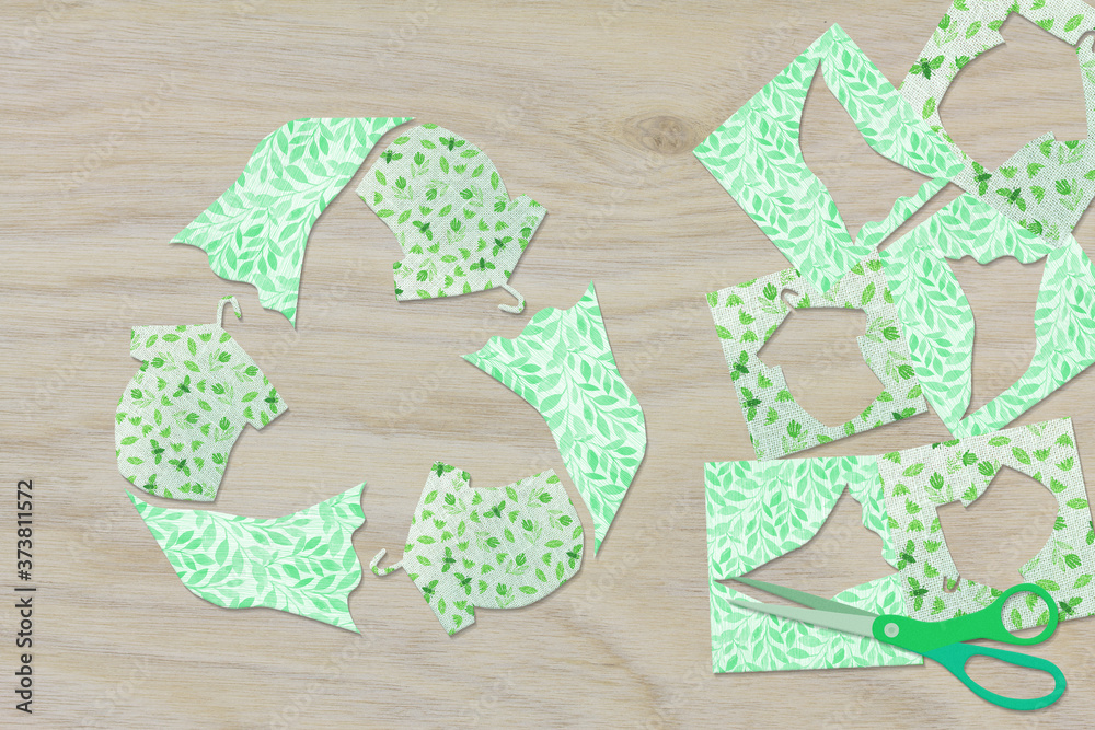 recycle clothes symbol recycle sign cut from reuse textiles on a wooden ...