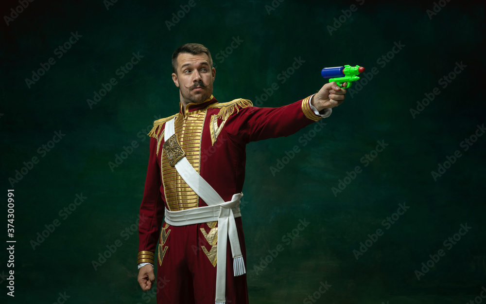 Warrior. Young man in suit as Nicholas II isolated on dark green ...