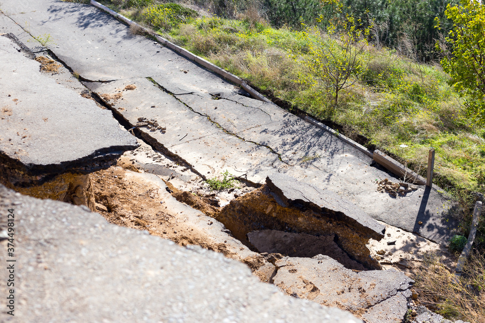 Broken road asphalt cracked and shifted by landslide after earthquake ...