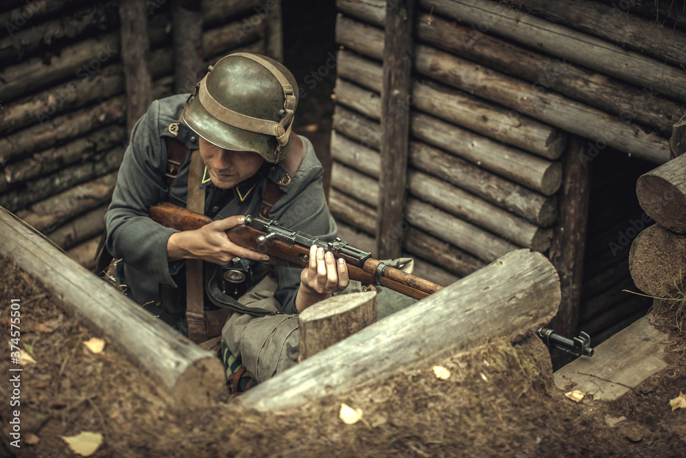 A soldier of the Finnish army during world war II, in a trench with a ...