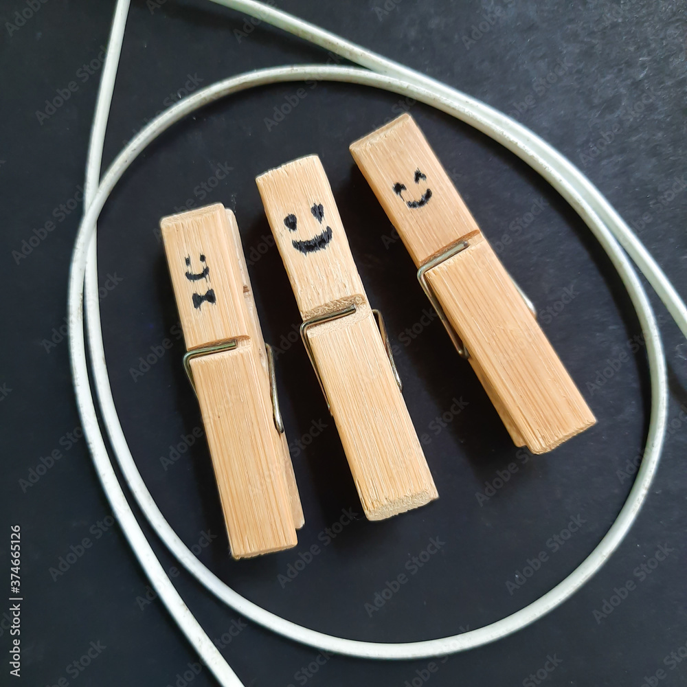 Smileys picture drawn in Hanging clip placed with wire in black paper ...