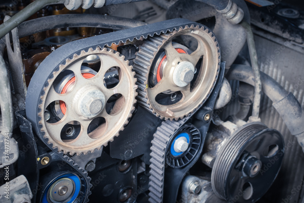 new timing belt with rollers installed on the old engine in a car ...