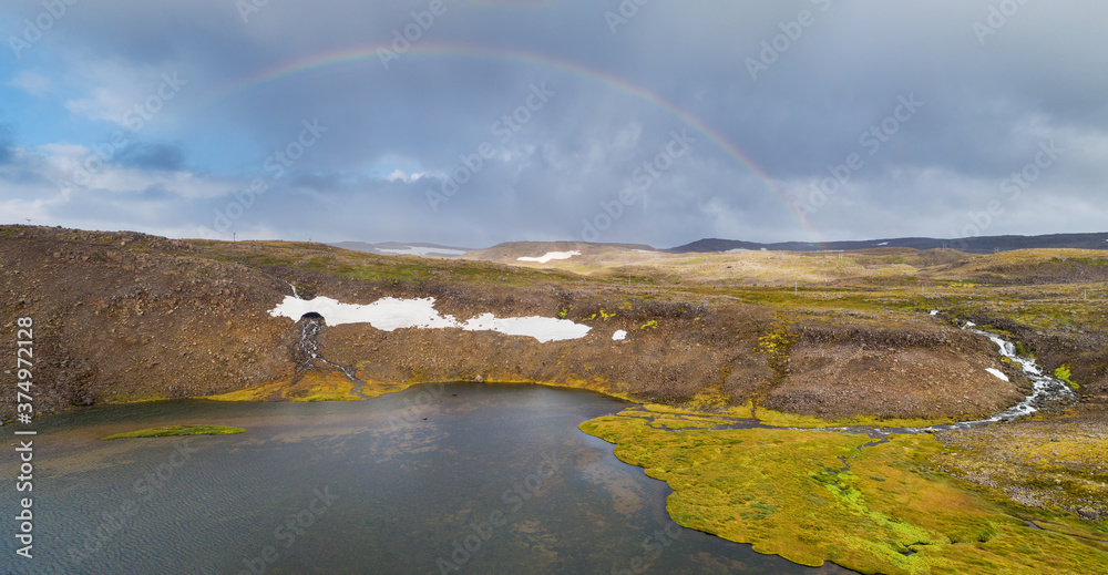 Panoramic aerial view of rainbow over mountain plateau with waterfall ...