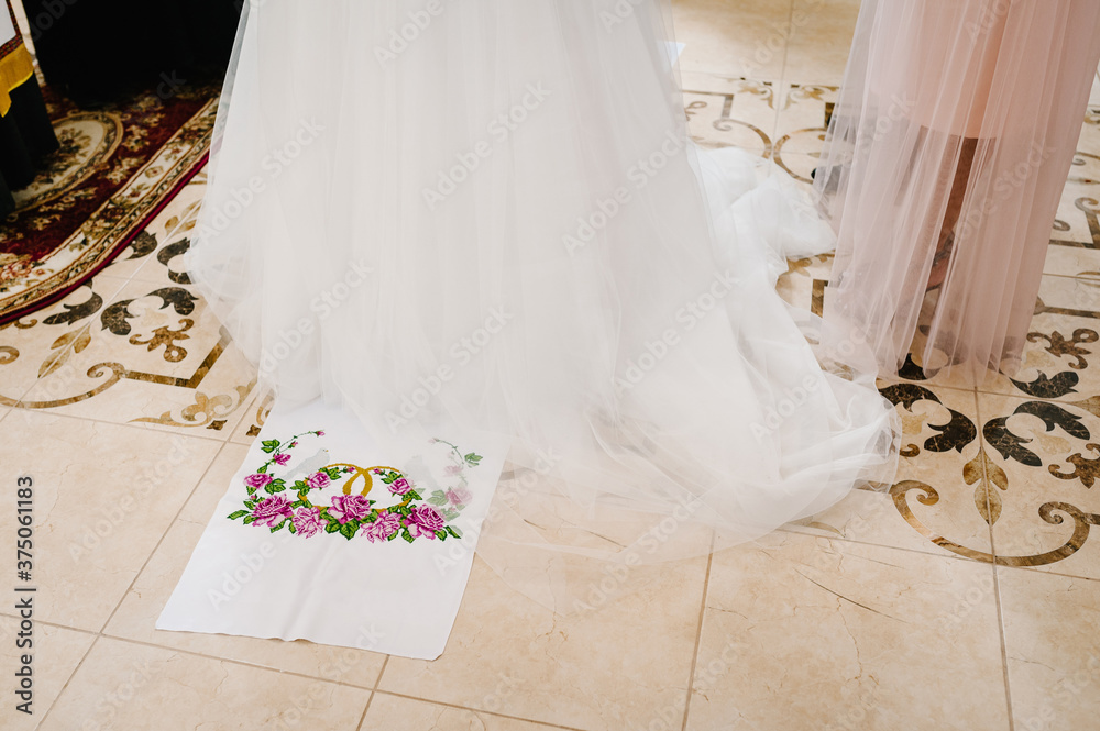 The legs of the bride and groom become on embroidered towel ...