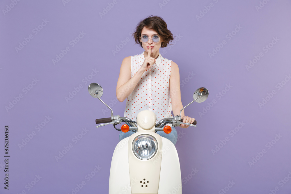 Secret young brunette woman in white dotted shirt glasses say hush be ...