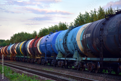 Freight train with petroleum tank cars on railroad. Rail cars carry oil ...