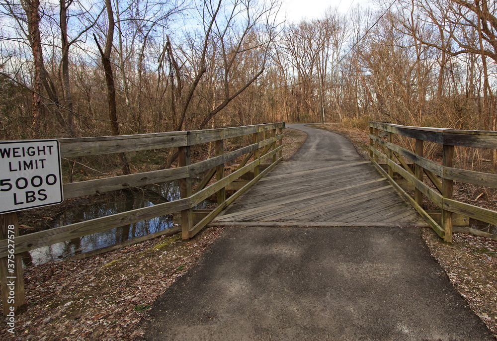 Bridge over the creek and wavy road with a 5000 pound weight limit sign ...