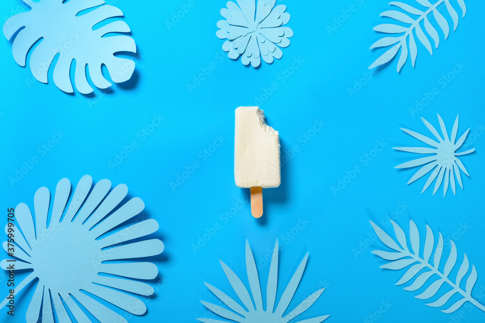 top view half baked cheese flavor popsicle with a bite on blue with ...