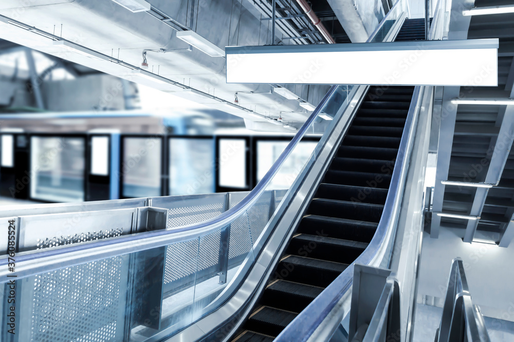 Blank sign board in subway train station with escalator background. It ...