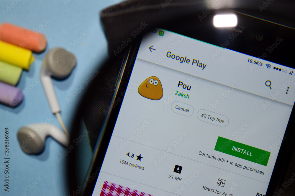 Foto de Stock POU dev app with magnifying on Smartphone screen. POU is ...