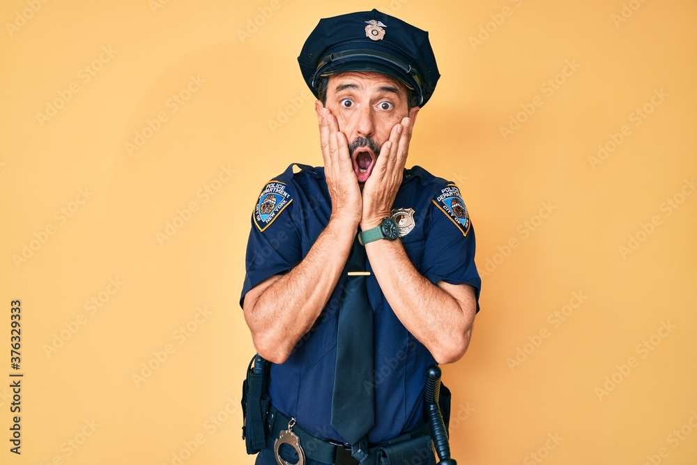 Middle age hispanic man wearing police uniform afraid and shocked ...